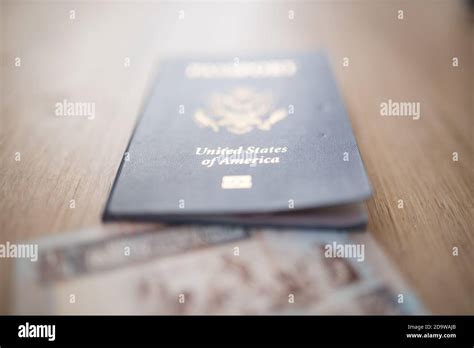 United States Of America Passport With A Kuwait Quarter Dinar Partially