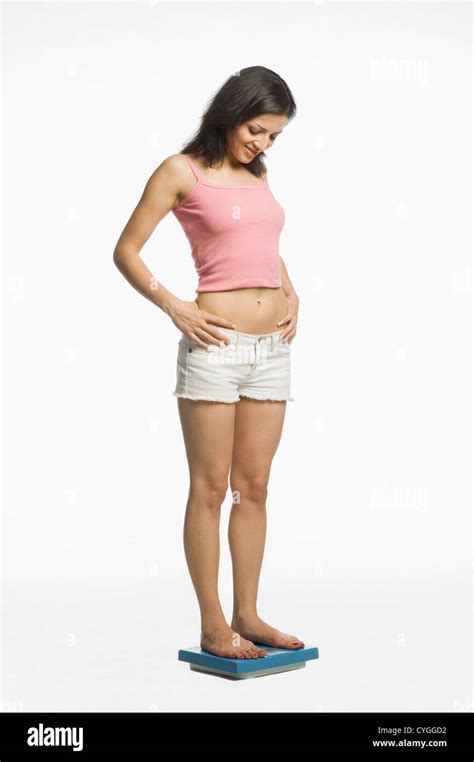 Woman Measuring Her Weight On A Weighing Scale Stock Photo Alamy