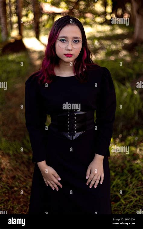 Young Caucasian Dark Haired Girl With Red Streaks In Black Dress Outfit
