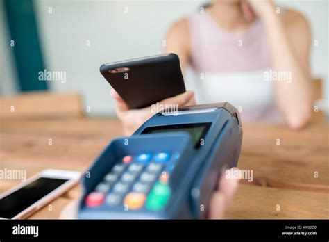 Female Pay On Mobile Phone With Pos Terminal Stock Photo Alamy