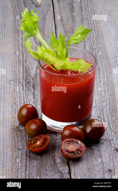 Brown Cherry Tomatoes Full Body And Halves With Glass Of Freshly