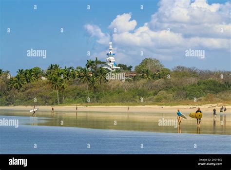 Surfers And The Quirky Tower Of The Nosara Beach Hotel At This Hip Surf