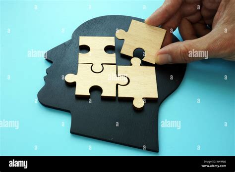 Problem Solving Concept Hand Puts Piece Of Puzzle On Head Shape Stock Photo Alamy