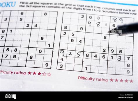 Attempting A Sudoku Puzzle Stock Photo Alamy