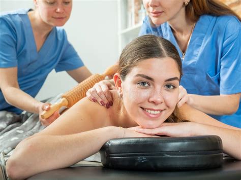 Portrait Of A Contented Young Woman Receiving A Massage Procedure Stock
