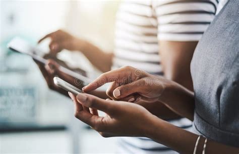 Networking Done In The Digital Age Closeup Shot Of Businesspeople Using Their Digital Devices