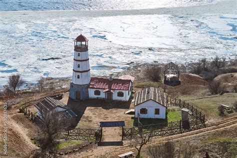 Beautiful White Red Lighthouse With Farm Utility Houses In Merzhanovo