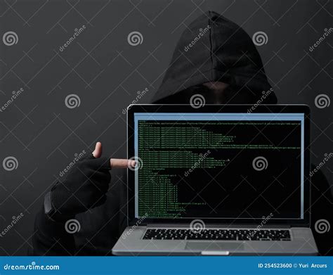See Your Data It Belongs To Me Now An Unidentifiable Computer Hacker Holding Up A Laptop