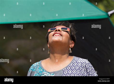 A Woman Wearing Eclipse Glasses Observes The Great American Eclipse On August 21 2017 Stock