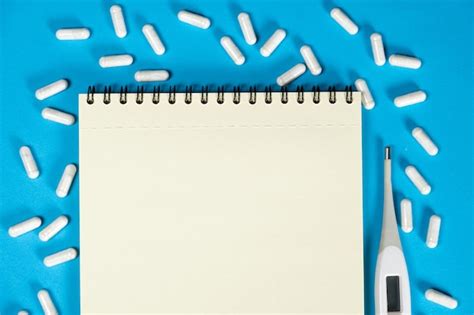 Premium Photo Medical Notepad With Pills On A Blue Background Space