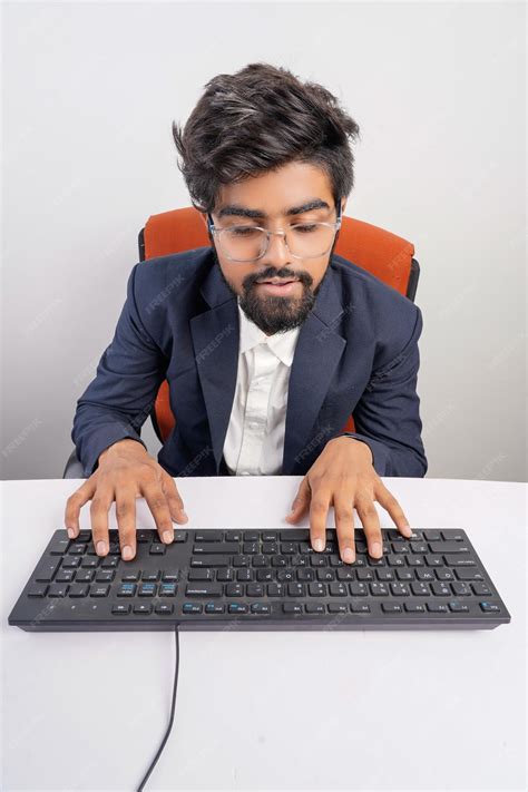 Premium Photo Indian Man In Glasses Working At The Computer His Hands Hover Over The Keyboard