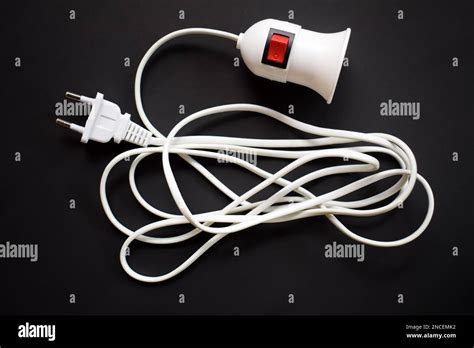 Light Bulb Socket With Long Wire Isolated On Black Background With On