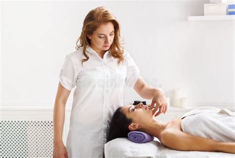 Woman Beautician Doctor Make Head Massage In Spa Wellness Center Stock