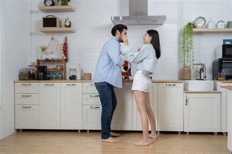 Romantic Young Couple Cooking Together In Kitchen Having Good Time
