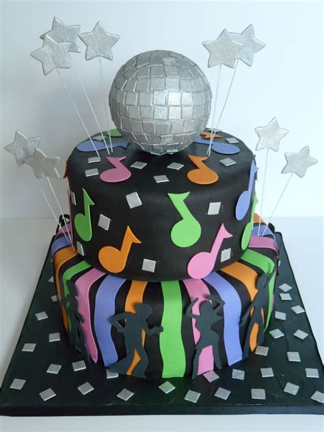 A Birthday Cake Decorated With Musical Notes And A Disco Ball On The