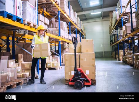 Female Warehouse Worker Loading Boxes Stock Photo Alamy