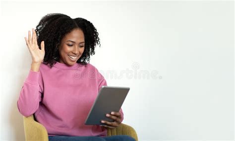 Cheerful Millennial African American Curly Lady In Casual Sits On