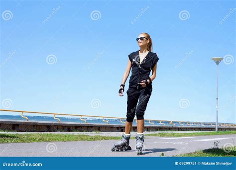 Young Beautiful Sporty And Fit Girl Rollerblading On Inline Skates
