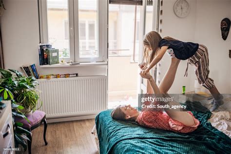 Mother And Daughter Enjoying Together And Having Fun In The Bedroom