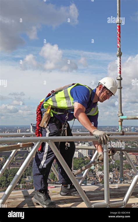 A Scaffolder Erects A Temporary Work Platform On A Tower Block High Stock Photo 163161352 Alamy
