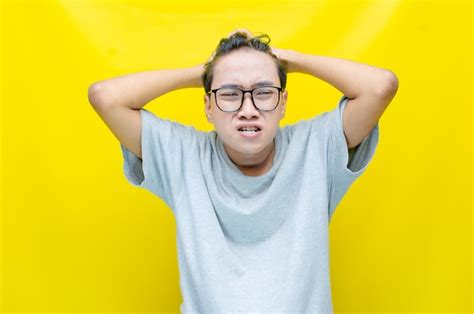 Premium Photo Hysterical Mad Depressed Asian Young Man Covers Ears By