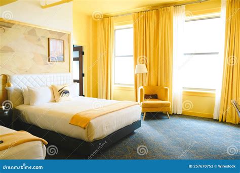 Interior Of A Bright Sunny Yellow Hotel Room With Art And A Reading