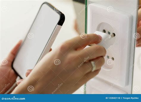 A Hand Pluging A Socket Into The Outlet Overloaded Outlet With An