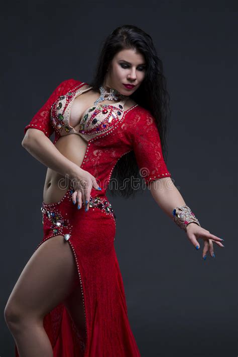 Young Beautiful Exotic Eastern Women In Ethnic Red Dress On Gray