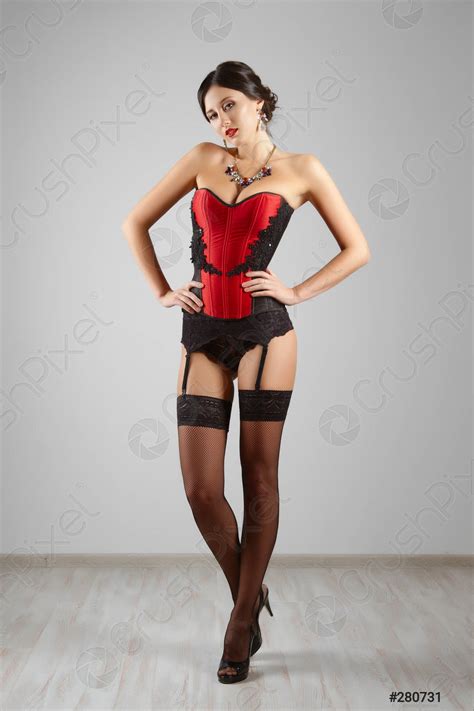 Sexy Girl In Burlesque Corset And Lingerie Posing Against Wall Stock