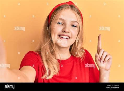 Beautiful Young Caucasian Girl Taking A Selfie Photo Smiling With An