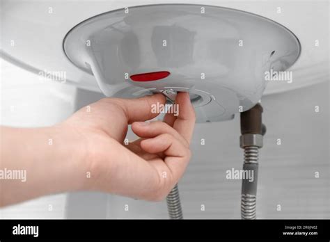 Woman Adjusting Maximum Energy Efficiency Indicator Indoors Closeup