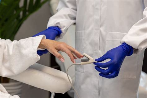 Unknown Nurse Checking Oxygen Level Through Oximeter To Female Patient Stock Photo Image Of