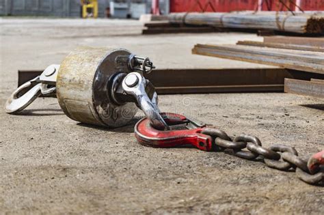 Metal Industrial Hook On The Concrete Floor Of A Steel Plant Close Up