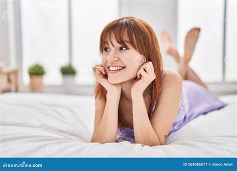 Young Woman Wearing Nightgown Lying On Bed At Bedroom Stock Image
