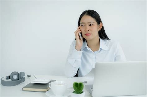 Premium Photo Young Asian Woman Making A Phone Call Analyzing Graphs To Set New Business Target