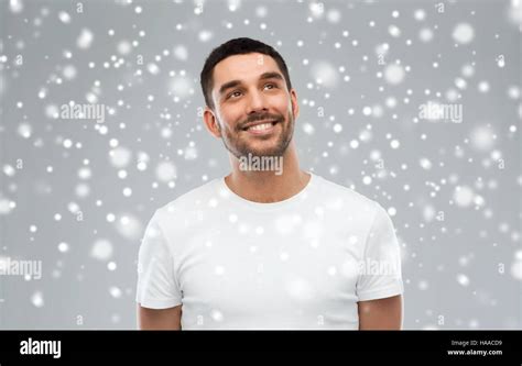 Smiling Man Looking Up Over Snow Background Stock Photo Alamy