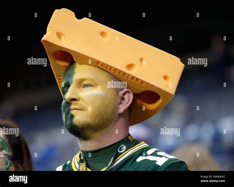 A Green Bay Packers Fan Watches During Warmups Before An Nfl Football