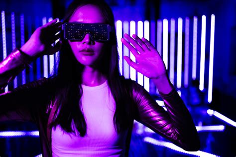 아시아 여자는 네온 불빛 벽 배경으로 게임을 한다 가상 현실 시뮬레이션 게임 및 미래 기술의 개념 25 29세에 대한 스톡 사진