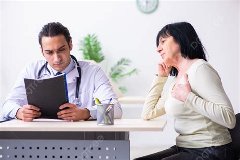 The Young Doctor Examining Senior Old Woman Young Doctor Examining