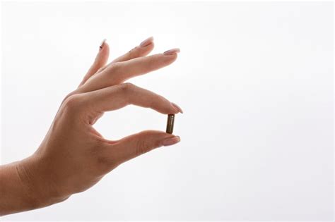 Free Photo Woman Holds In Her Hand A Capsule With Vitamins Or Oil