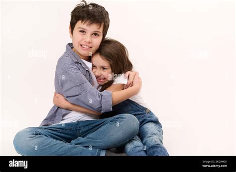 Mischievous Boy And Cute Girl Brother And His Younger Sister Hugging
