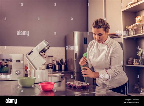 Famous Chef Pleasant Young Woman Preparing Muffins While Participating