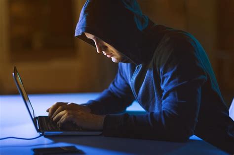 premium photo hacker using laptop computer for cyber attack