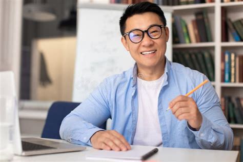 Happy Korean Tutor Man Taking Notes Having Online Class Indoor Stock