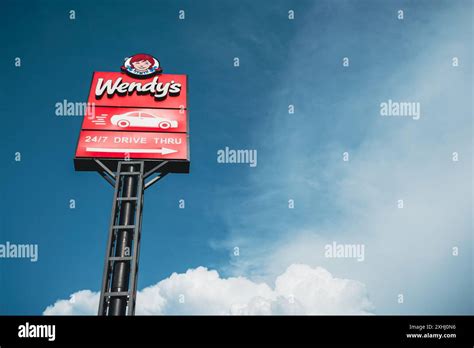 Wendys Drive Thru Sign Standing High Against A Blue Sky Background