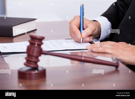 Male Judge Writing On Paper In Courtroom Stock Photo Alamy