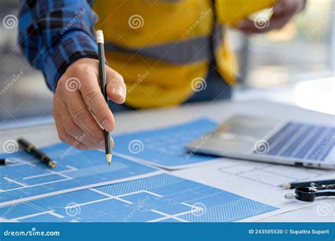 Architect Pointing To Building Plans For Review And Editing Architect