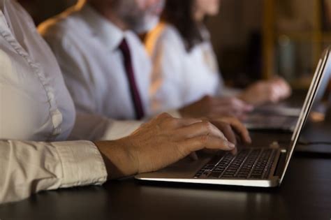 Free Photo Partial View Of Business People Using Laptops