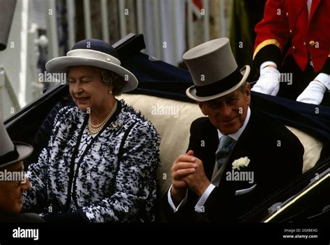 Queen Elizabeth Ii And The Duke Of Edinburgh Ride Down The Course On