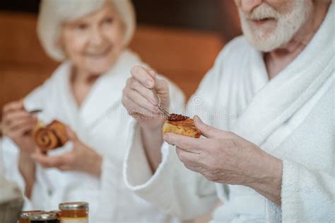 A Senior Happy Couple Enjoying Breakfast While Staying In Bed Stock